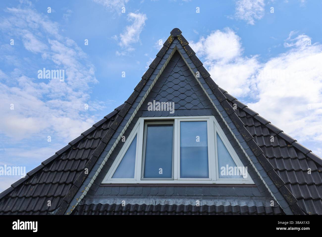 Modern triangular dormer window with slate cladding and black roof ...