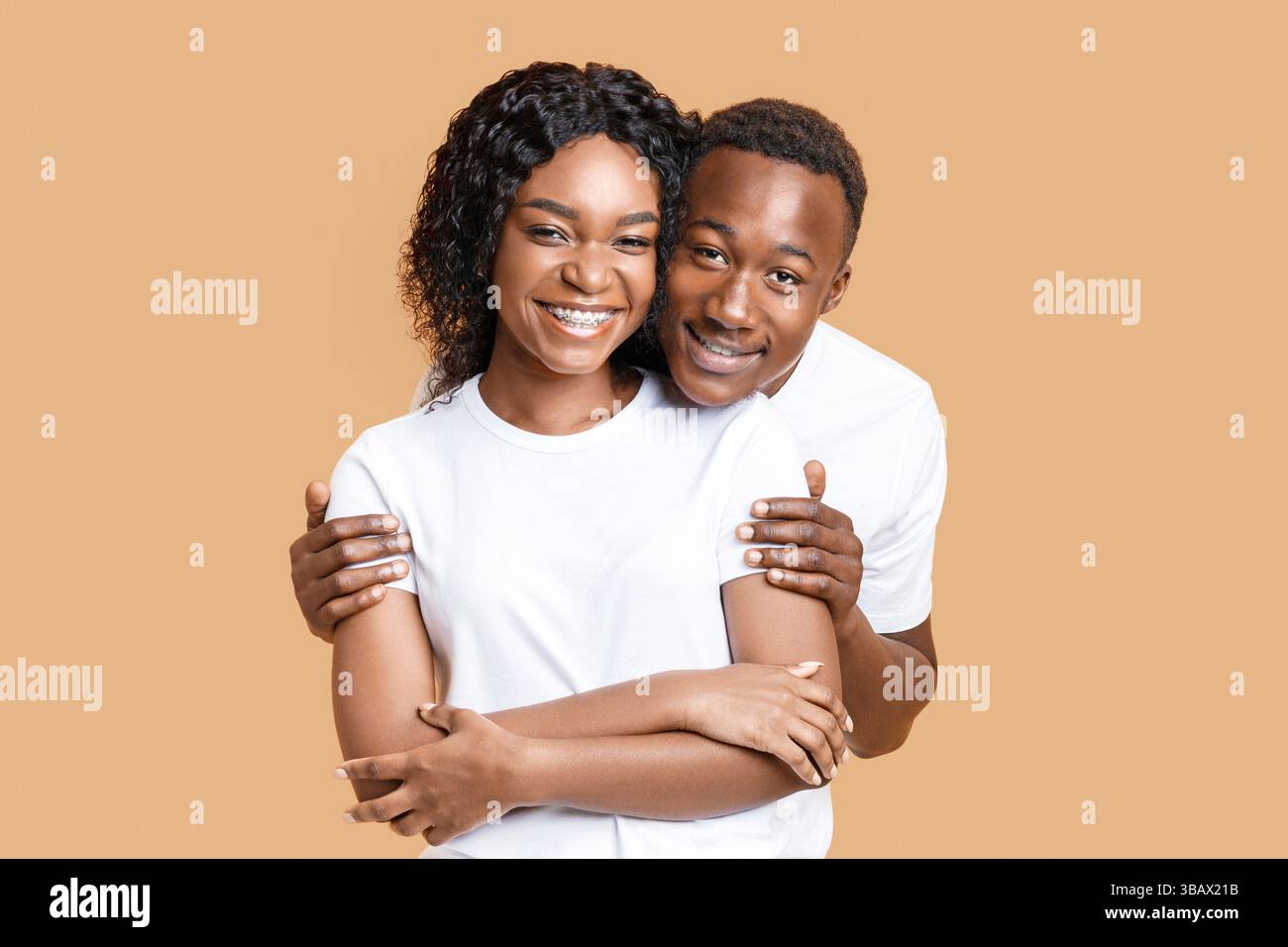 Black guy hugging his girlfriend from behind Stock Photo - Alamy