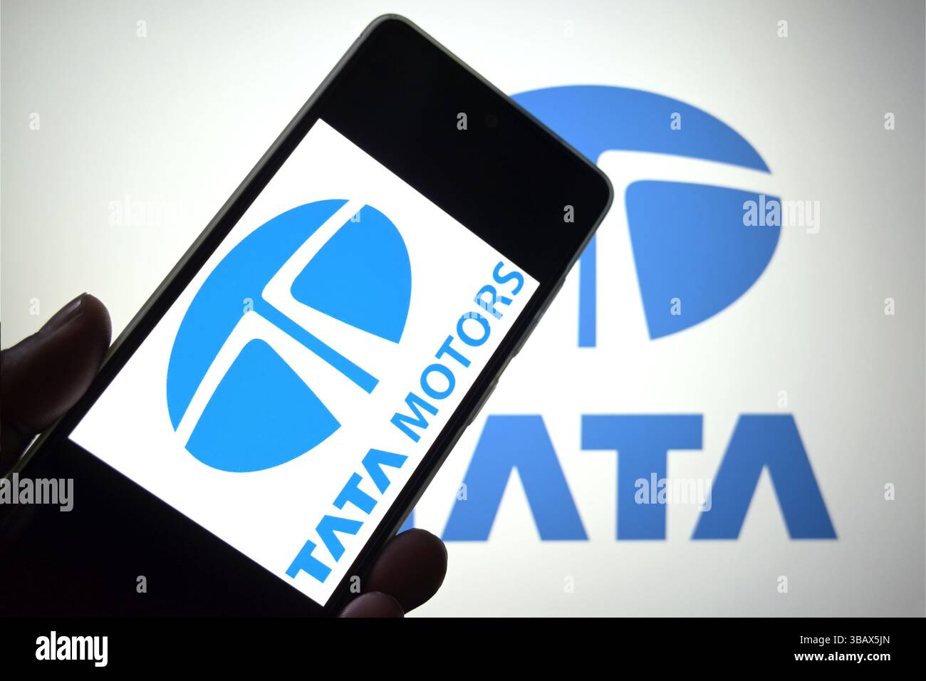 In this photo illustration, a TATA Motors logo is seen displayed on a ...