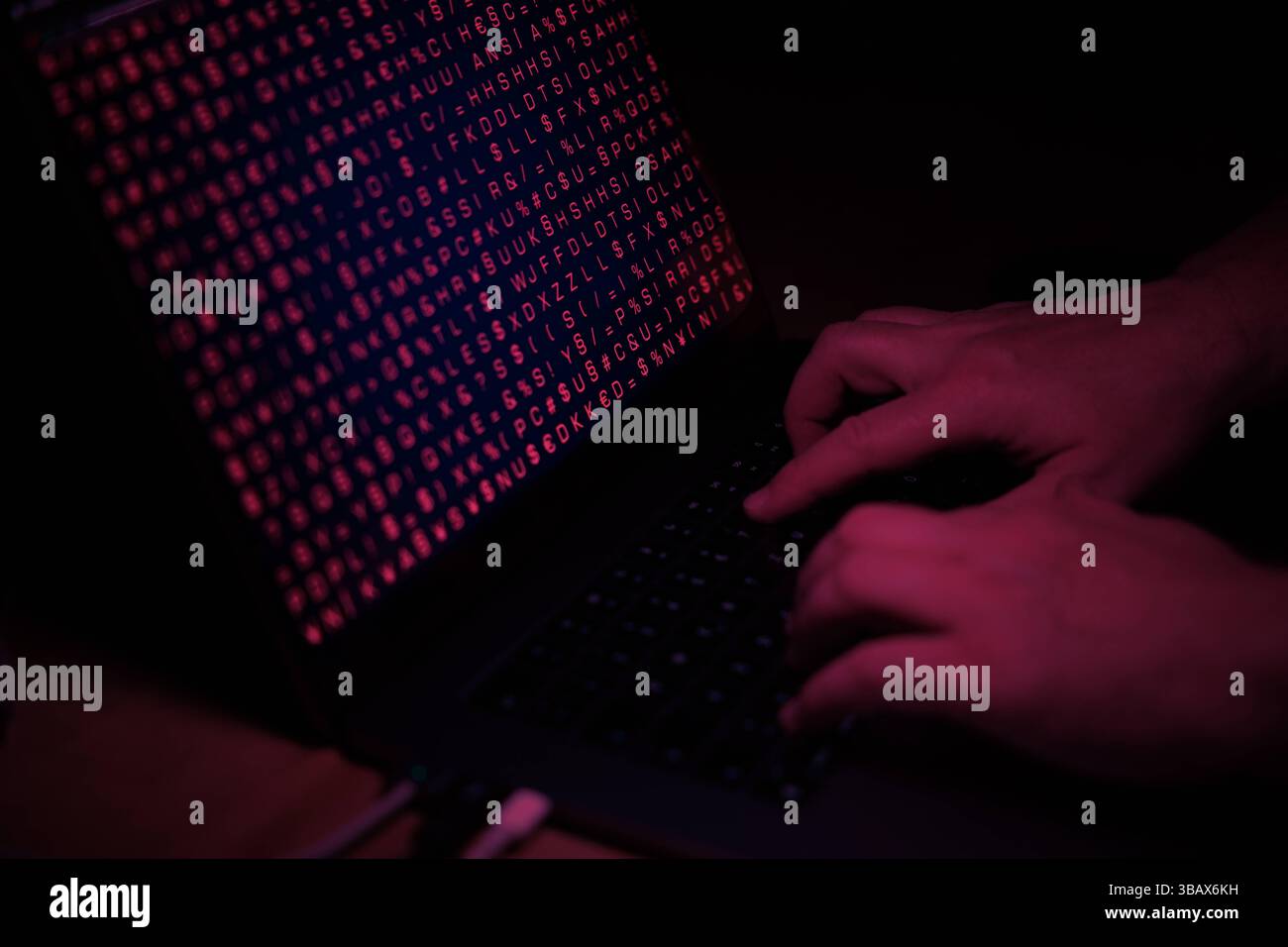 Hands typing on the computer keyboard, red light, computer crime ...