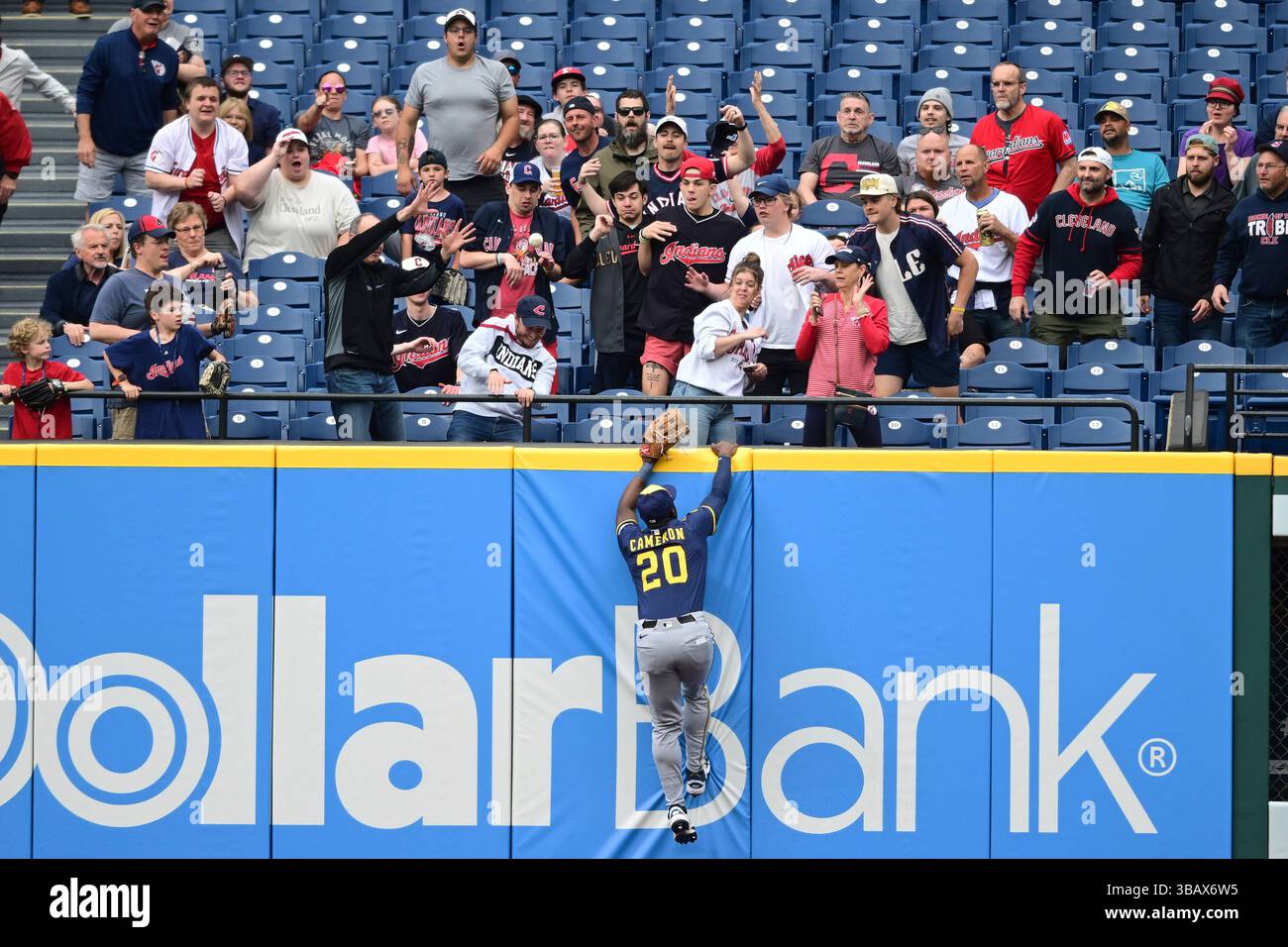 Milwaukee Brewers right fielder Daz Cameron climbs the wall as fans ...