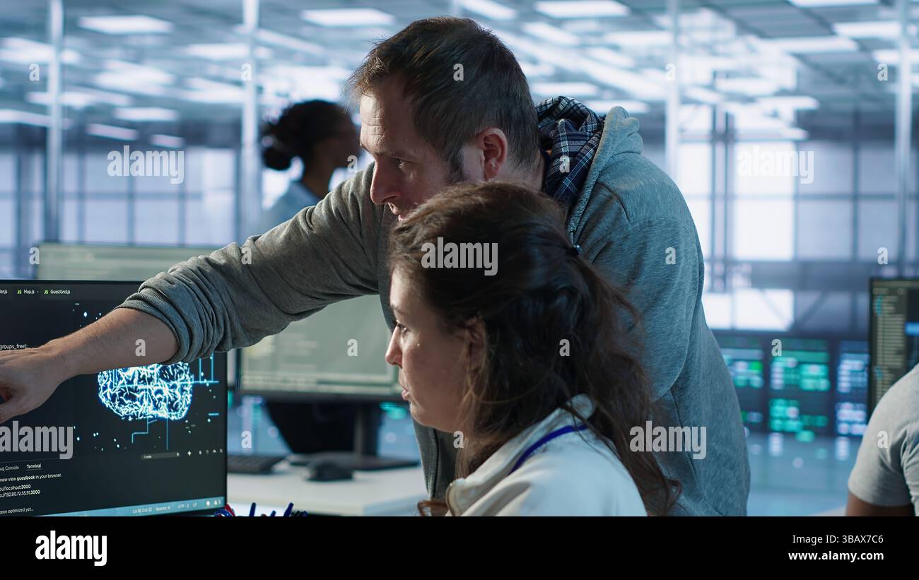 IT team members programming scripts on computer, employing AI machine learning. Software ...