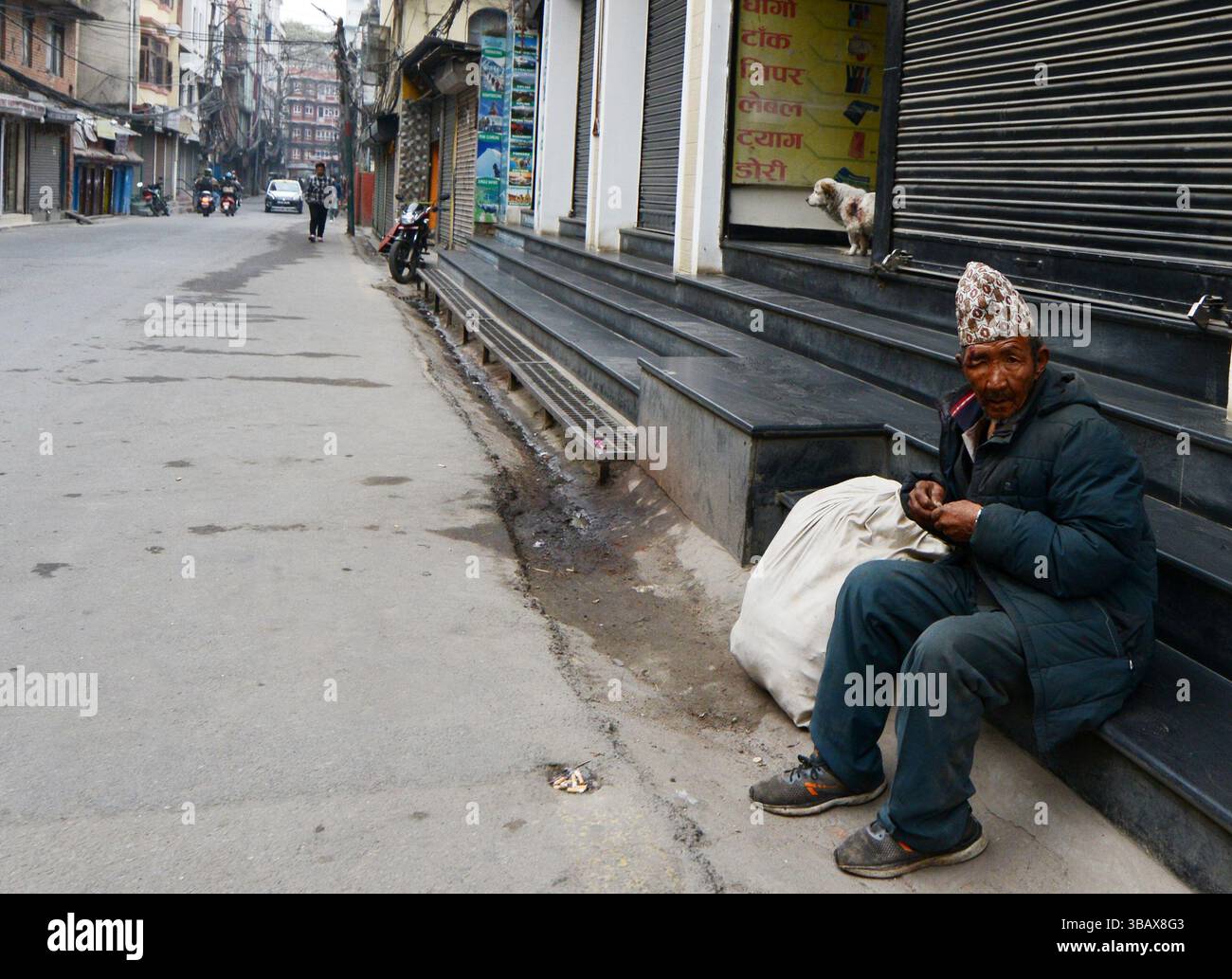 A Nepali man sitting outside a shop in Kathmandu, Nepal Stock Photo - Alamy