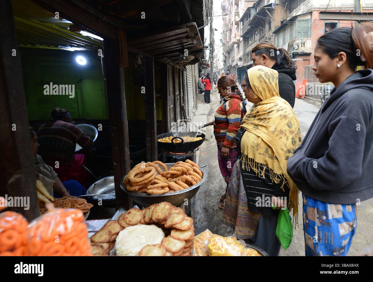 Customers standing in line at a fried bread and sweets shop in Kathmandu, Nepal Stock Photo - Alamy