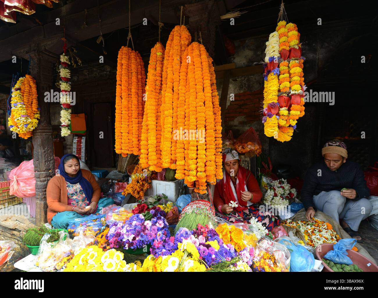 Flower vendors selling garlands at the ground floor of a beautiful old ...