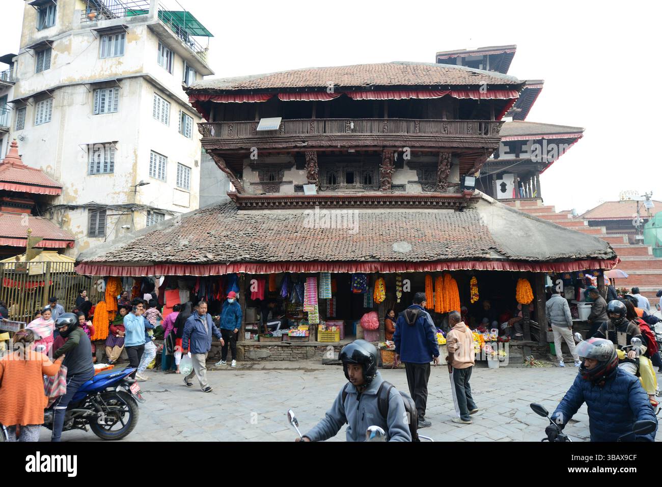 Flower vendors selling garlands at the ground floor of a beautiful old ...
