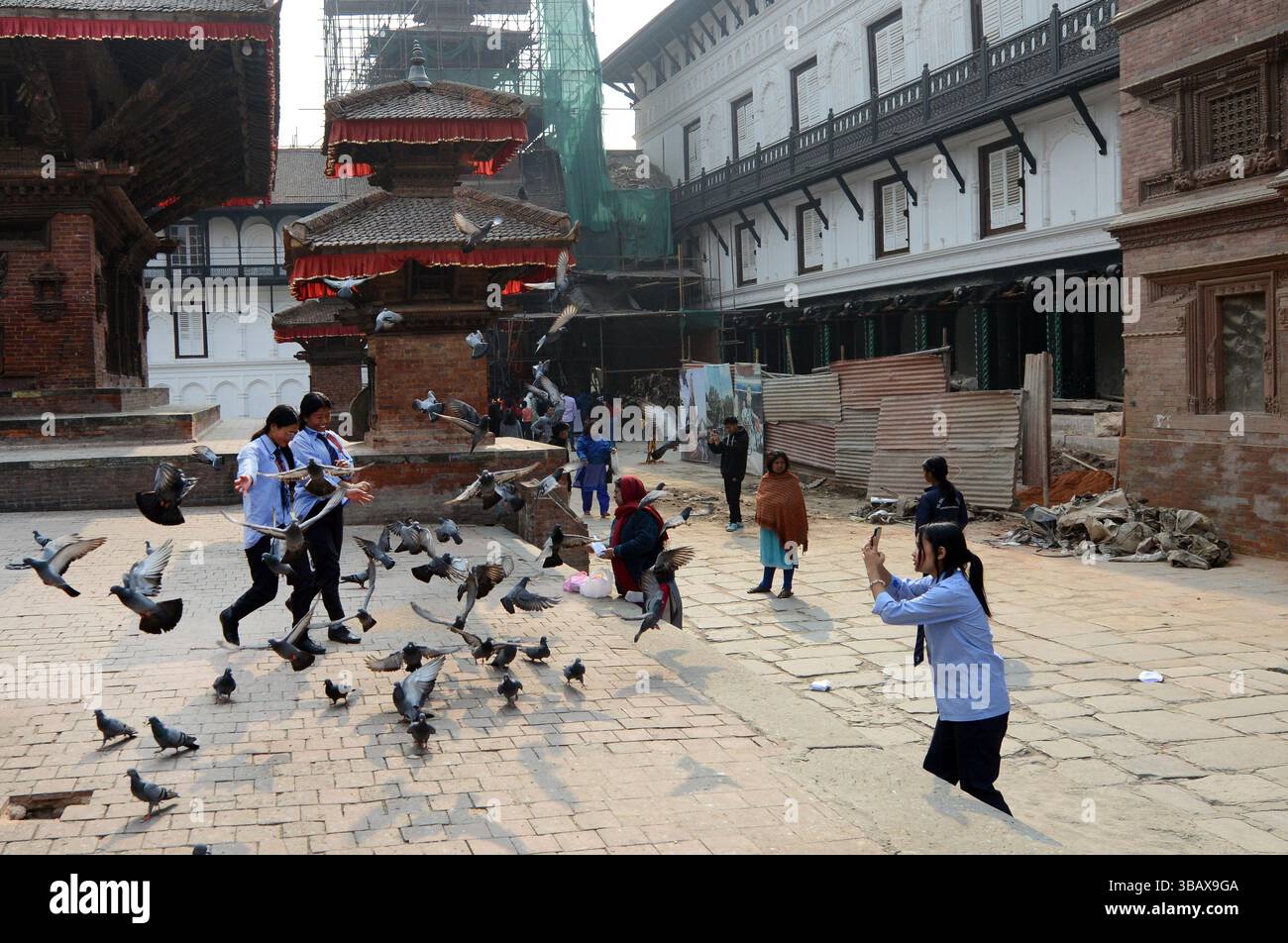 Nepali teenagers playing with the pigeons at the Durbar Square in ...