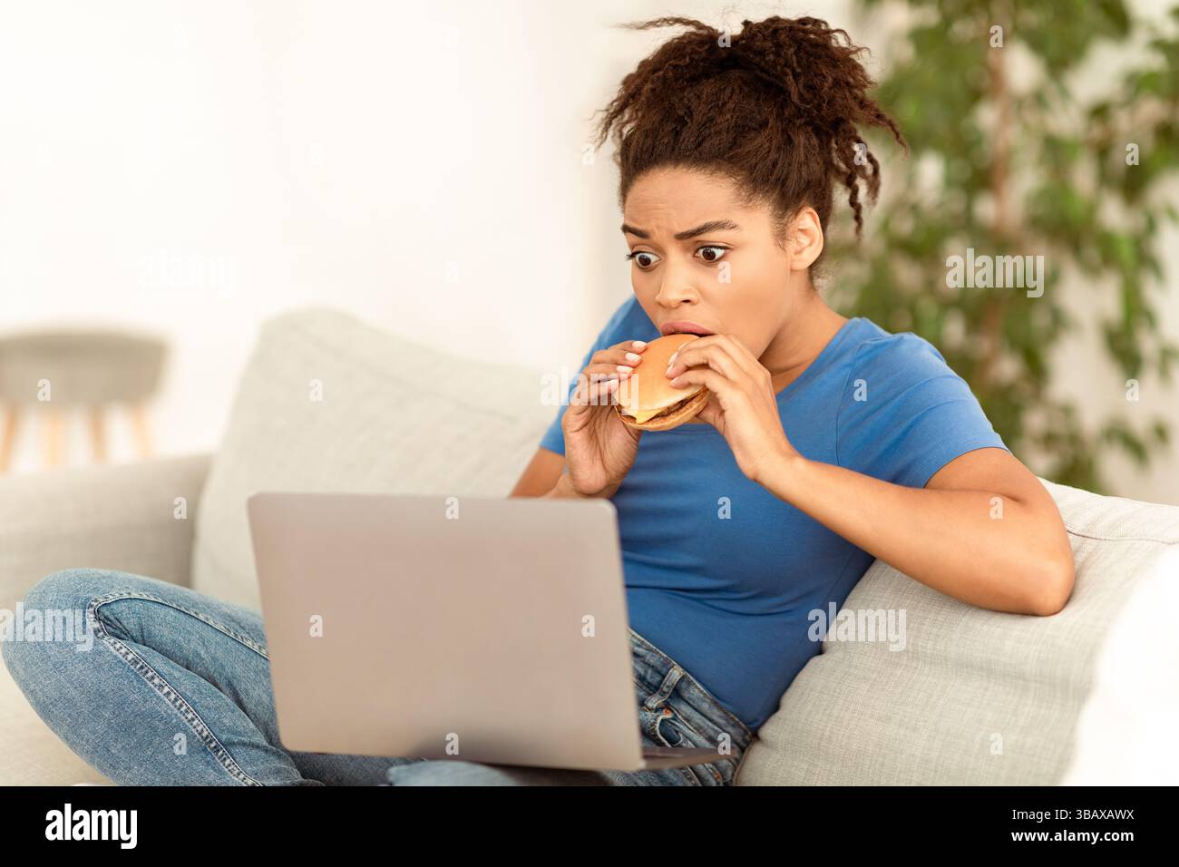 Black Lady Biting Burger Using Laptop Browsing Internet Sitting Indoor ...