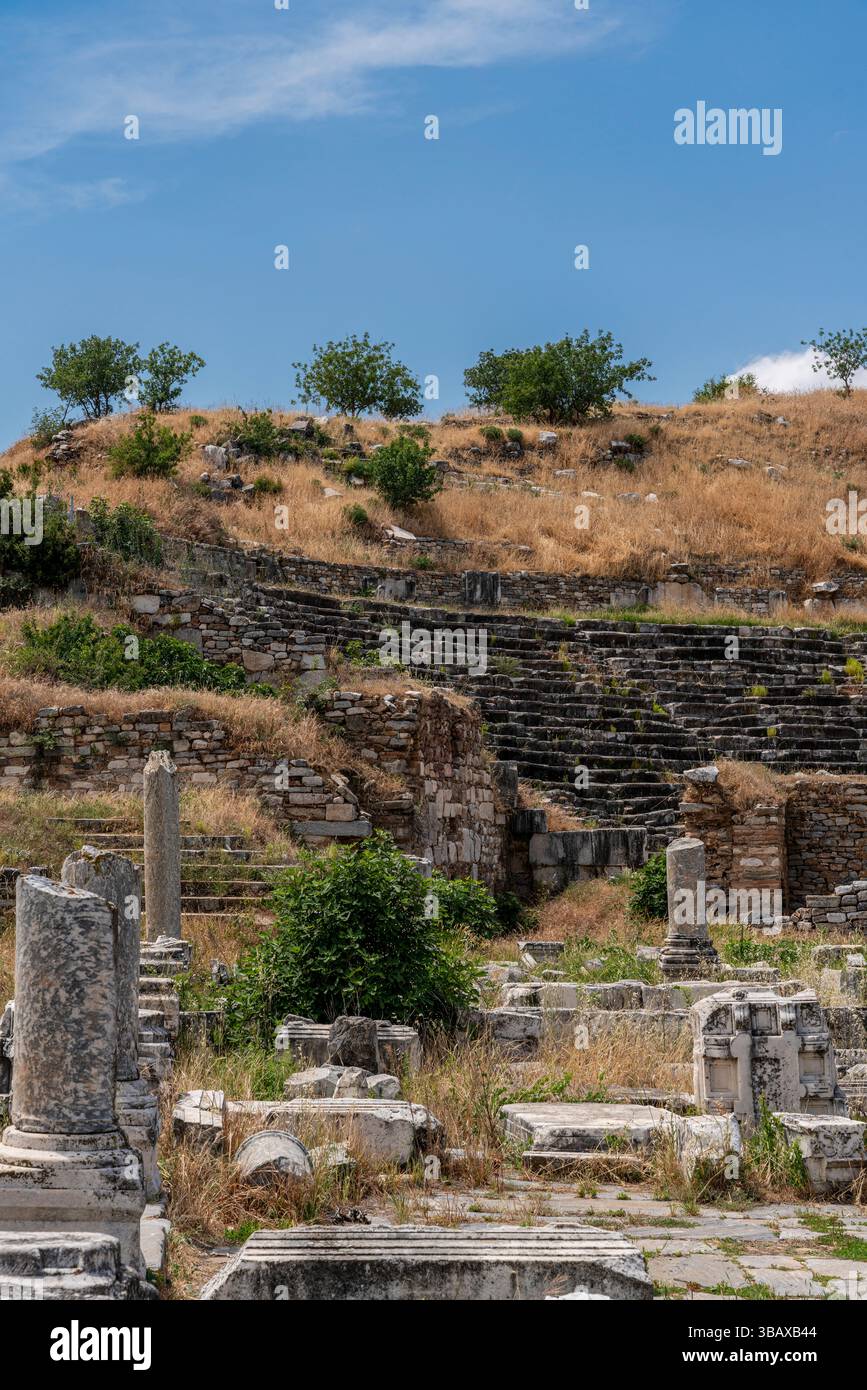 Stone remnants of an amphitheater surrounded by grass, showcasing the ...