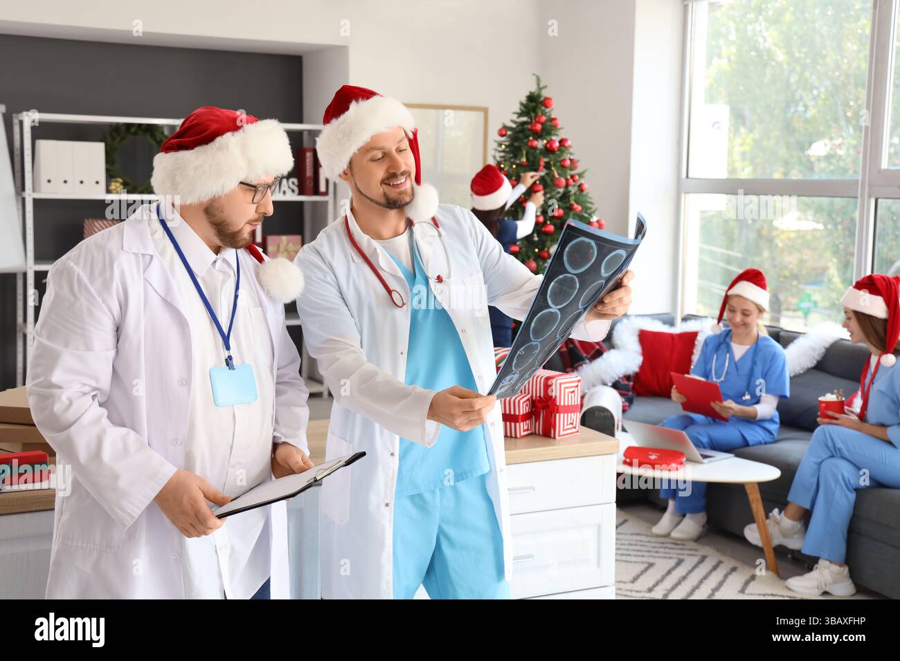 Male doctors in Santa hats with MRI scan at hospital on Christmas eve ...