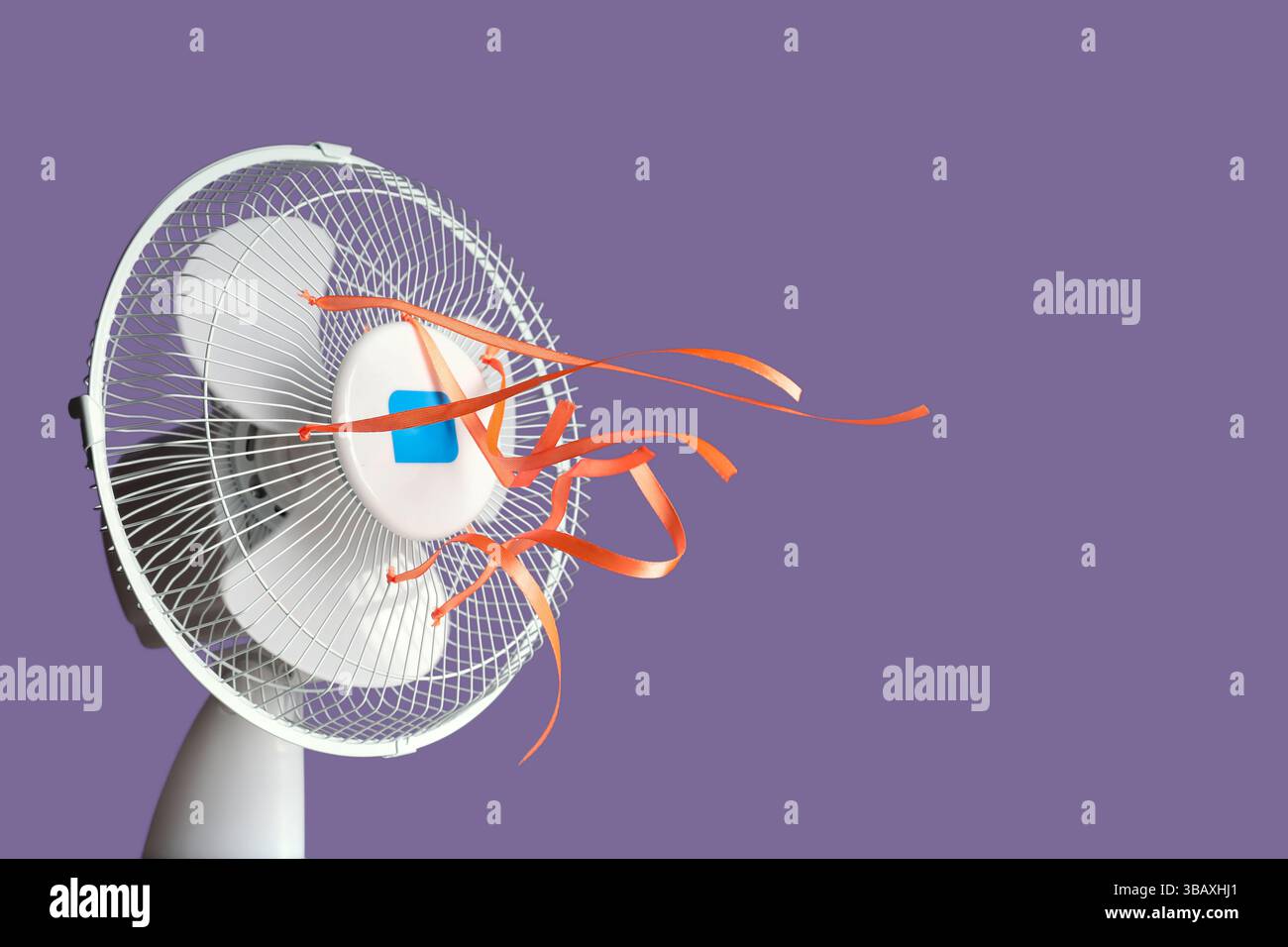 Electric fan with fluttering ribbons on violet background Stock Photo ...