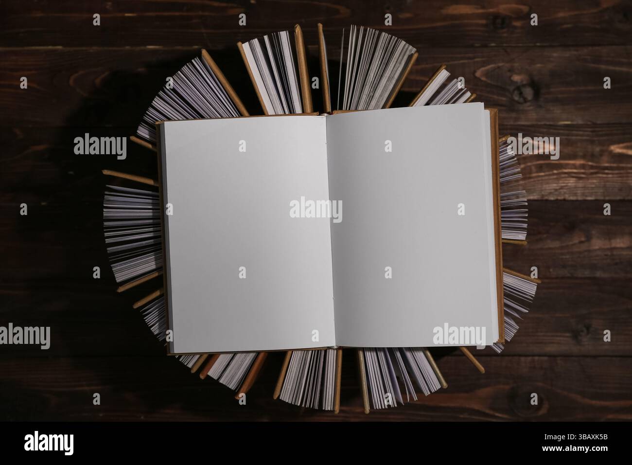Open book on top of many half open ones, top view Stock Photo - Alamy