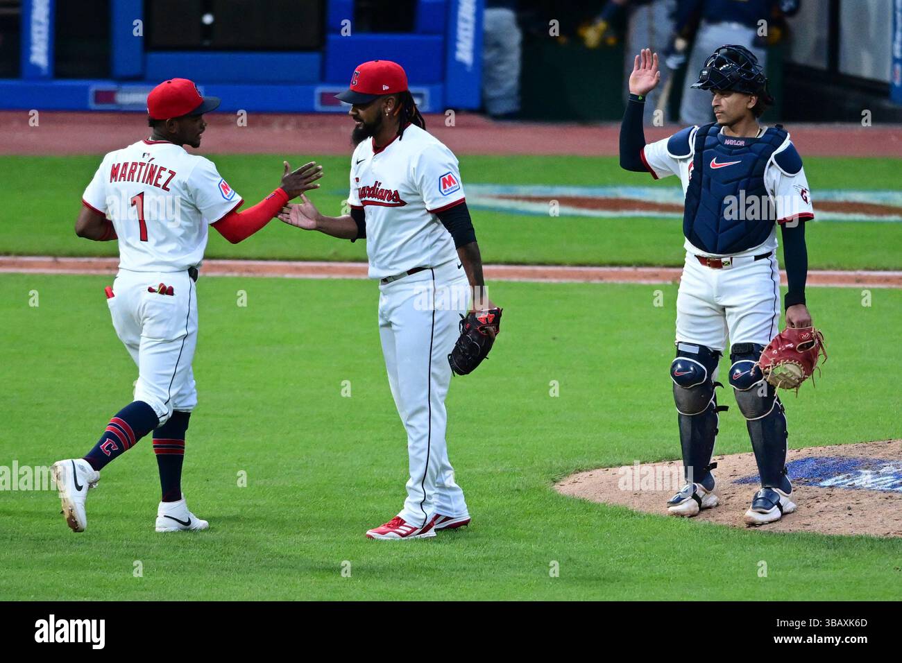 Cleveland Guardians pitcher Emmanuel Clase, center, is congratulated by ...