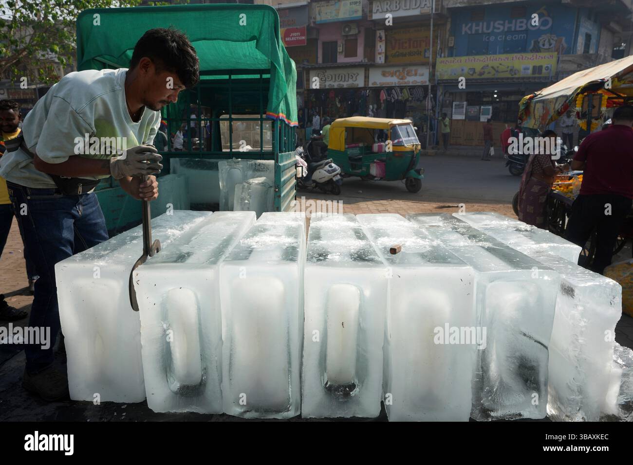 A man arranges ice blocks to sell at his stall in Ahmedabad, India ...