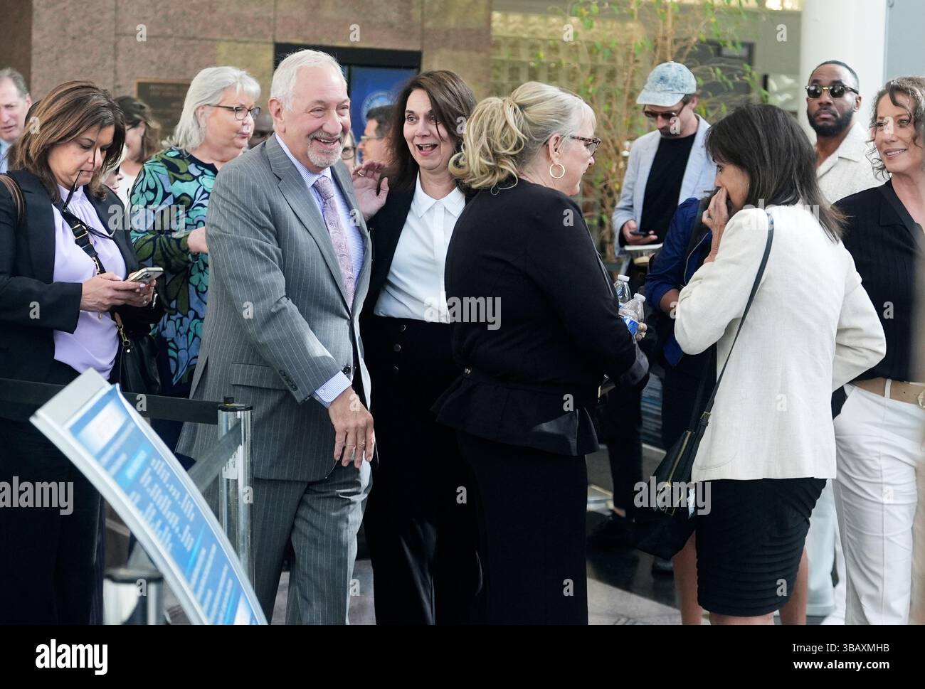 Attorney Mark Geragos, left, with family and supporters of Erik and ...