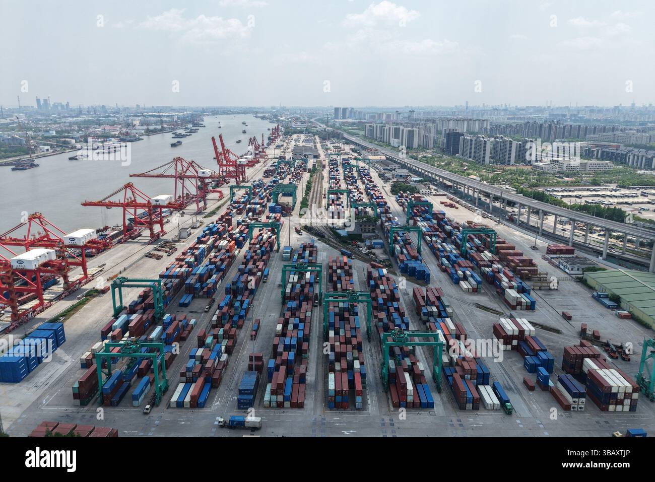 SHANGHAI, CHINA - MAY 14, 2025 - A cargo ship is loading and unloading ...