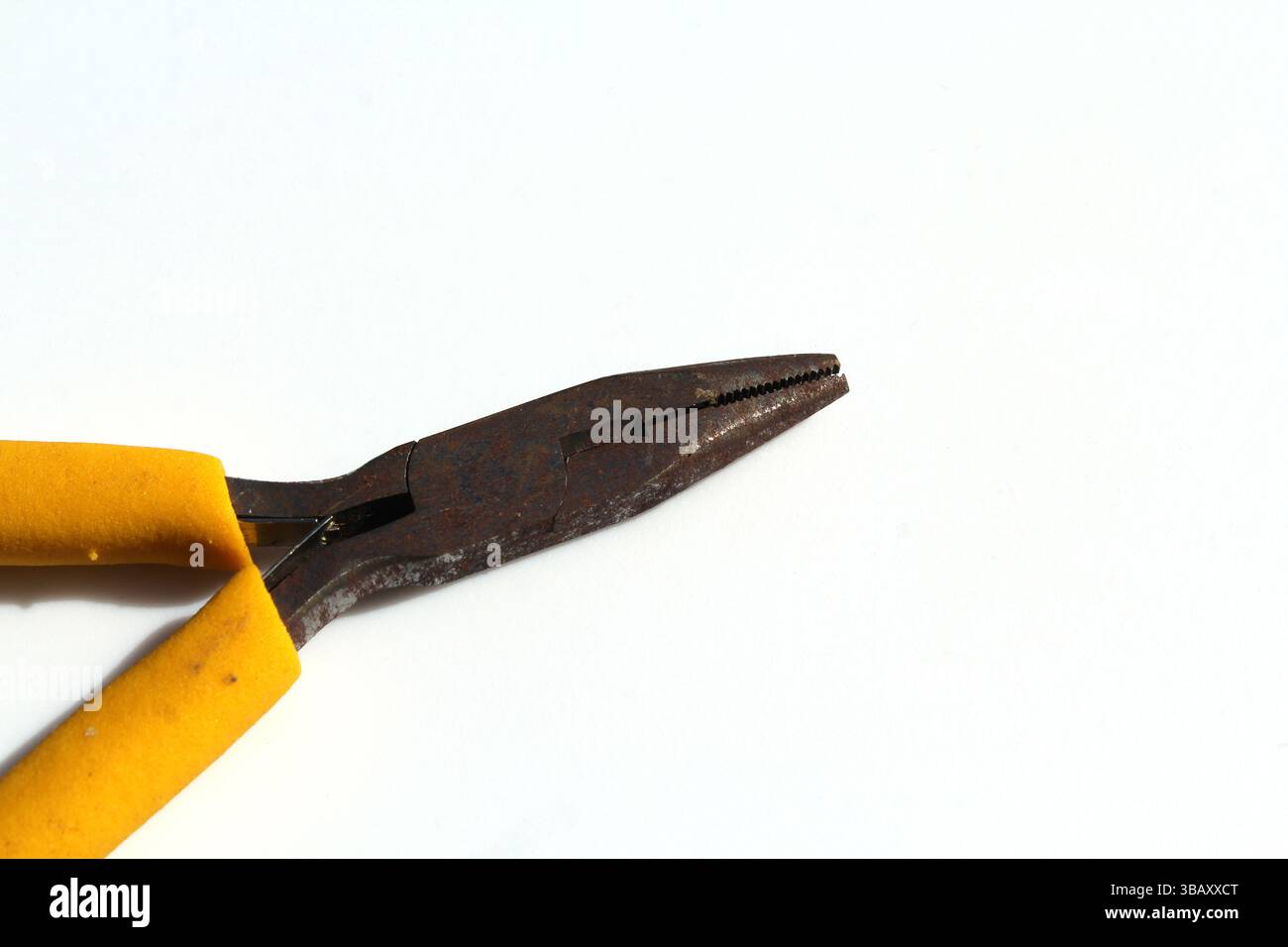 Rusty pliers with yellow handles on a white background Stock Photo - Alamy