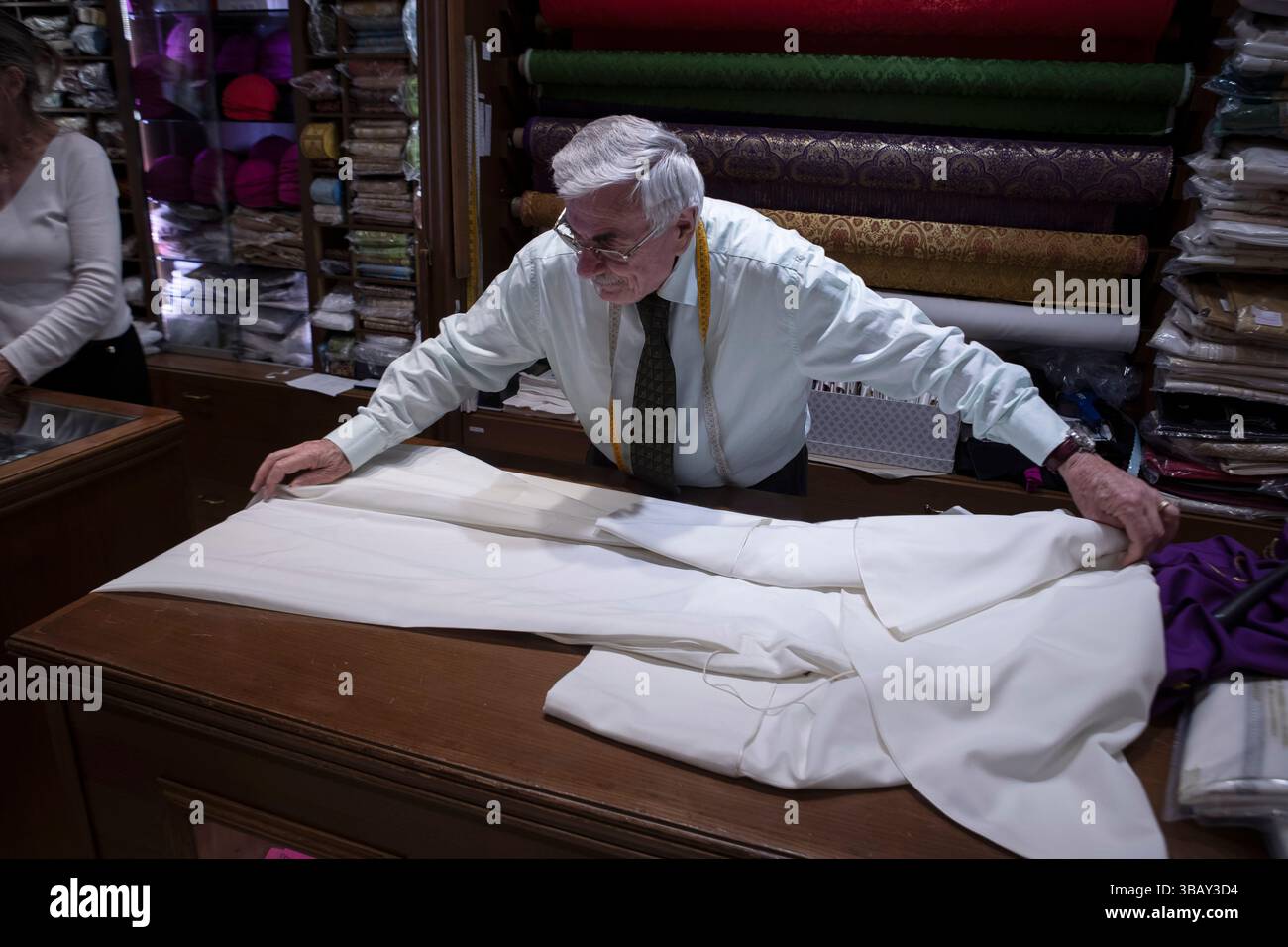 Tailor Raniero Mancinelli makes the finishing touches to the last of ...