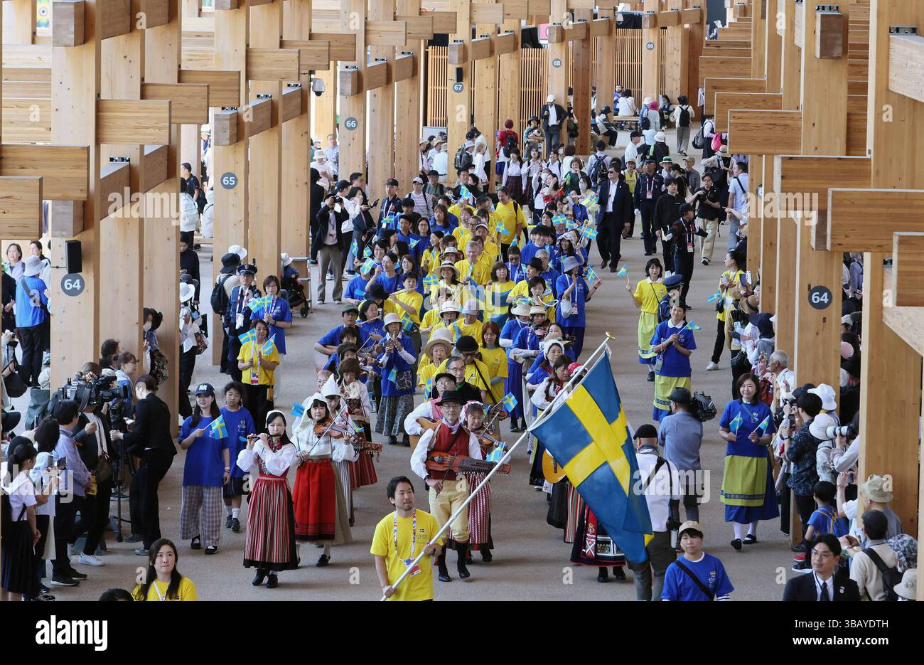 Many attendees, clad in traditional Swedish costumes and blue or yellow ...