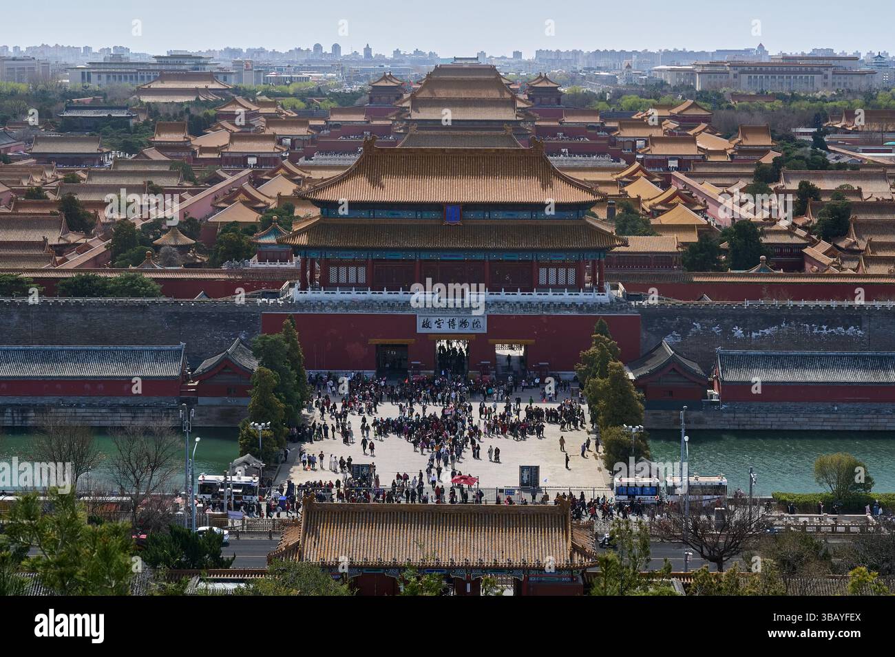 Wide view of a temple complex in central Beijing framed by trees with a ...
