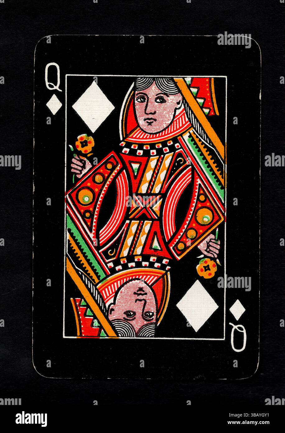 A vintage playing card in the suit of diamonds isolated on a black ...