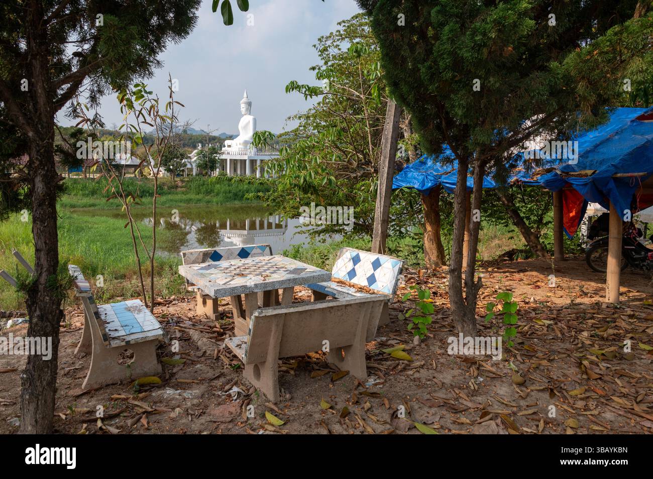 From a garden chess board table towards a tall white buddha sitting on ...