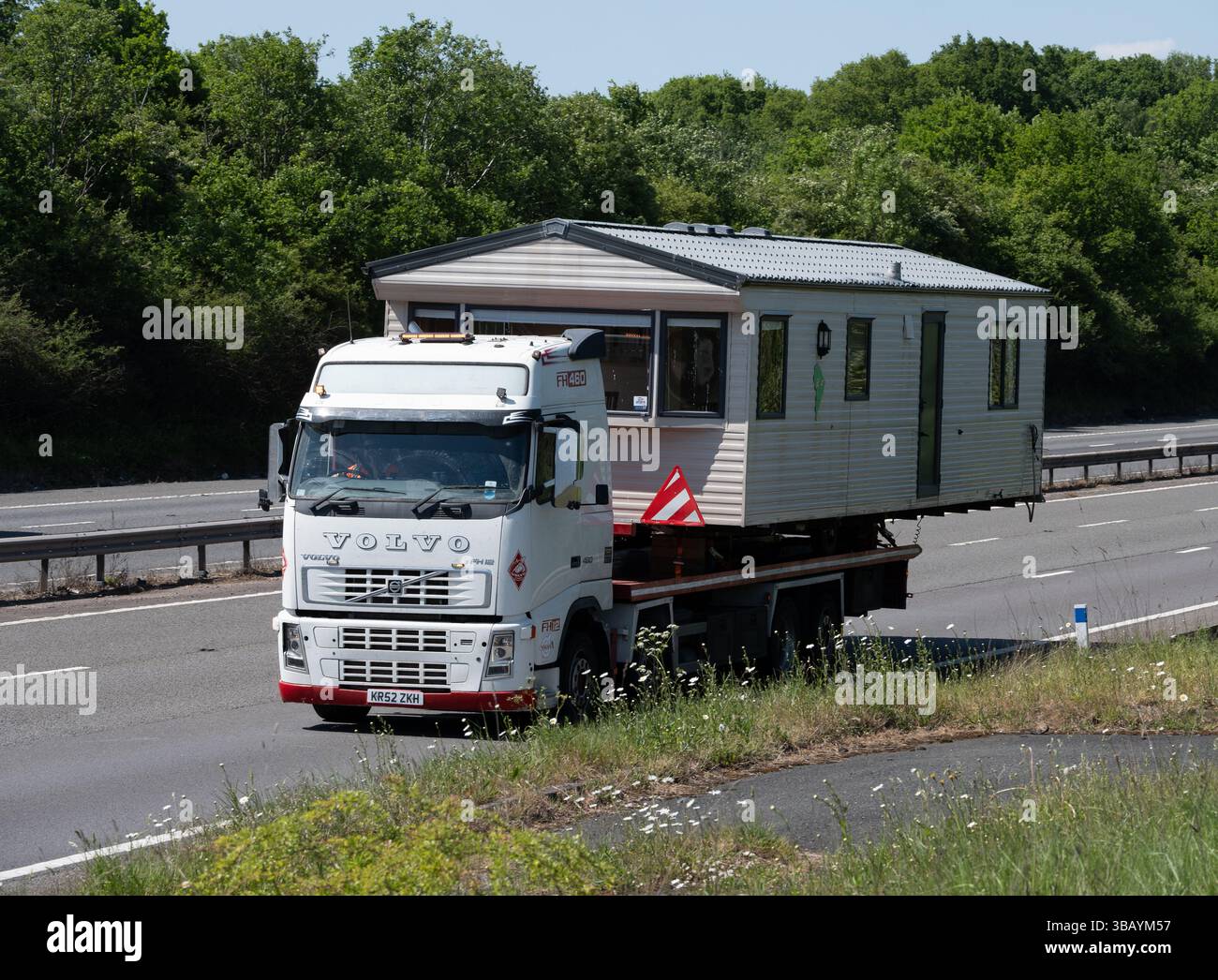 Volvo lorry carrying a large load on the M40 motorway, Warwickshire, UK ...