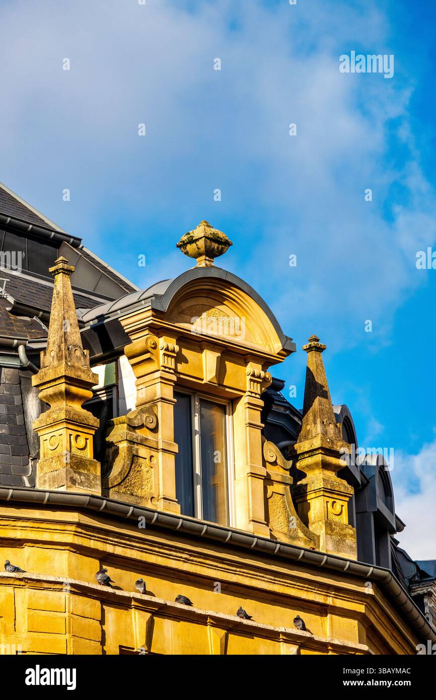 Ornate dormer with sculptural details on a historic façade in ...