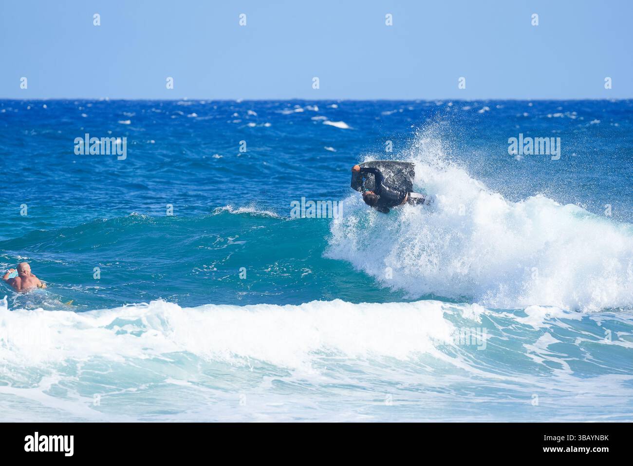 Bodyboarder performs skill flip and roll in powerful wave, creating a ...