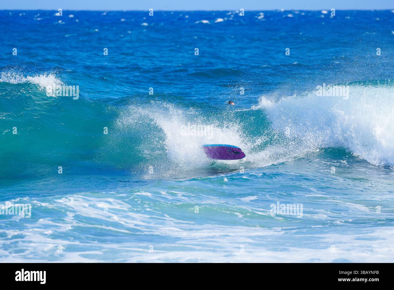 Bodyboarder performs skill flip and roll in powerful wave, creating a ...