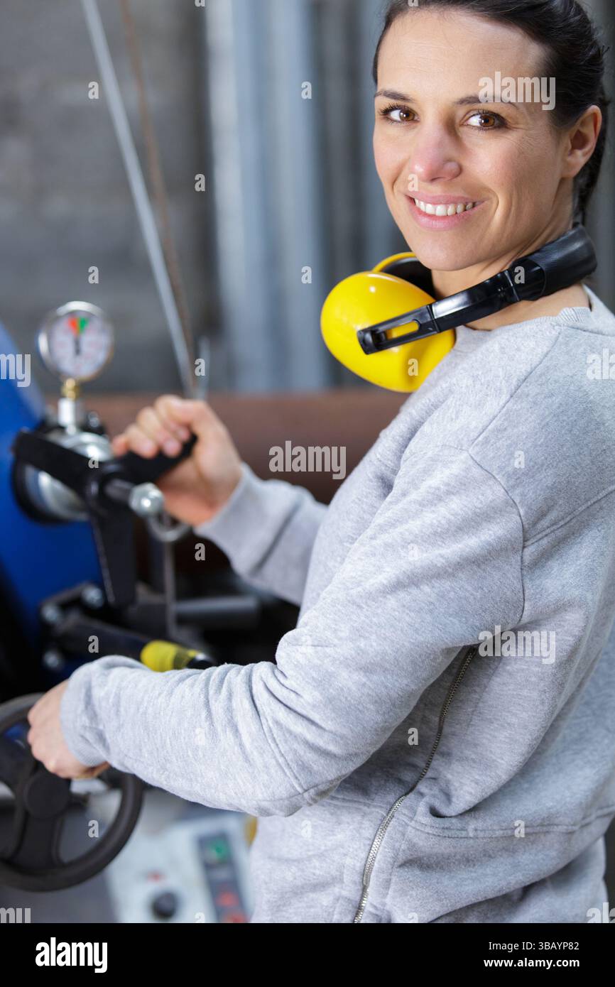 female factory worker setting up machine units in modern plant Stock ...