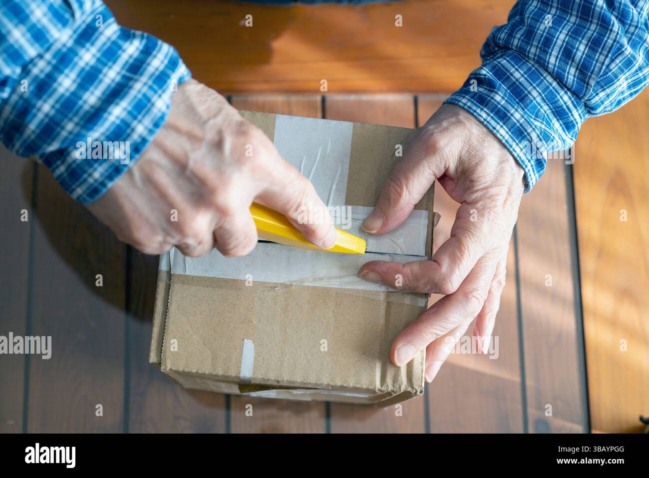 Person unsealing cardboard box using hi-res stock photography and ...