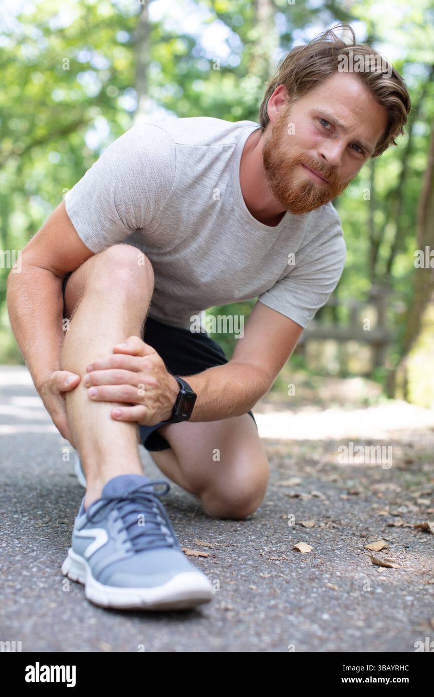 ankle sprained man suffering from injury Stock Photo - Alamy