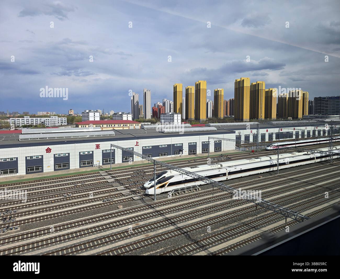 Bullet train on multiple railway tracks near high-rise buildings in a ...