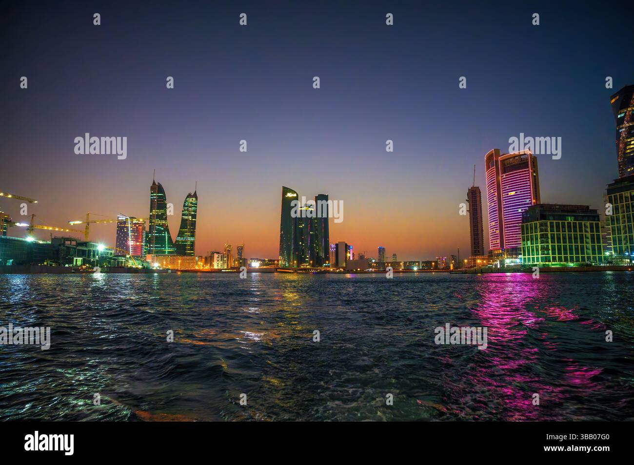 Night view of modern resorts reflecting in water in Bahrain Stock Photo ...