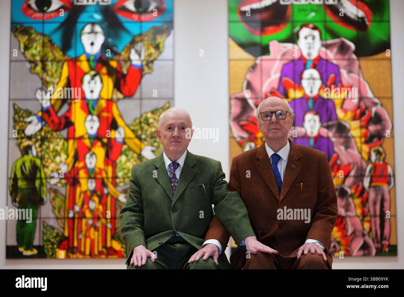 Art duo Gilbert & George pose with artwork at their exhibition called ...