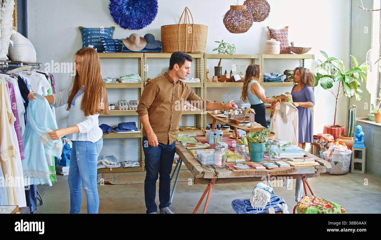 Interior Of Fashion Store With Customers Being Helped By Staff Stock ...