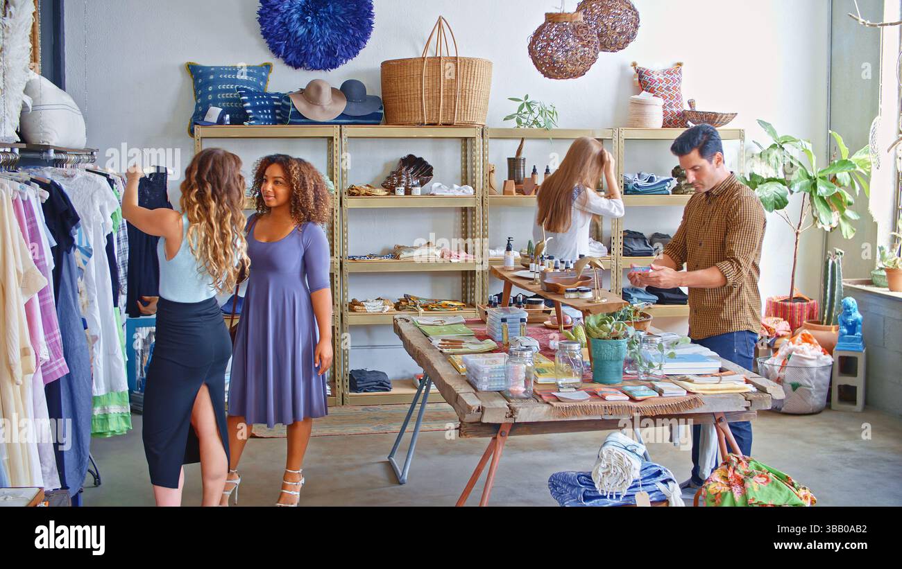 Interior Of Fashion Store With Customers Being Helped By Staff Stock ...