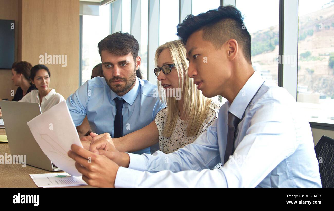 Business Team Around Table In Modern Office Collaborating Together ...