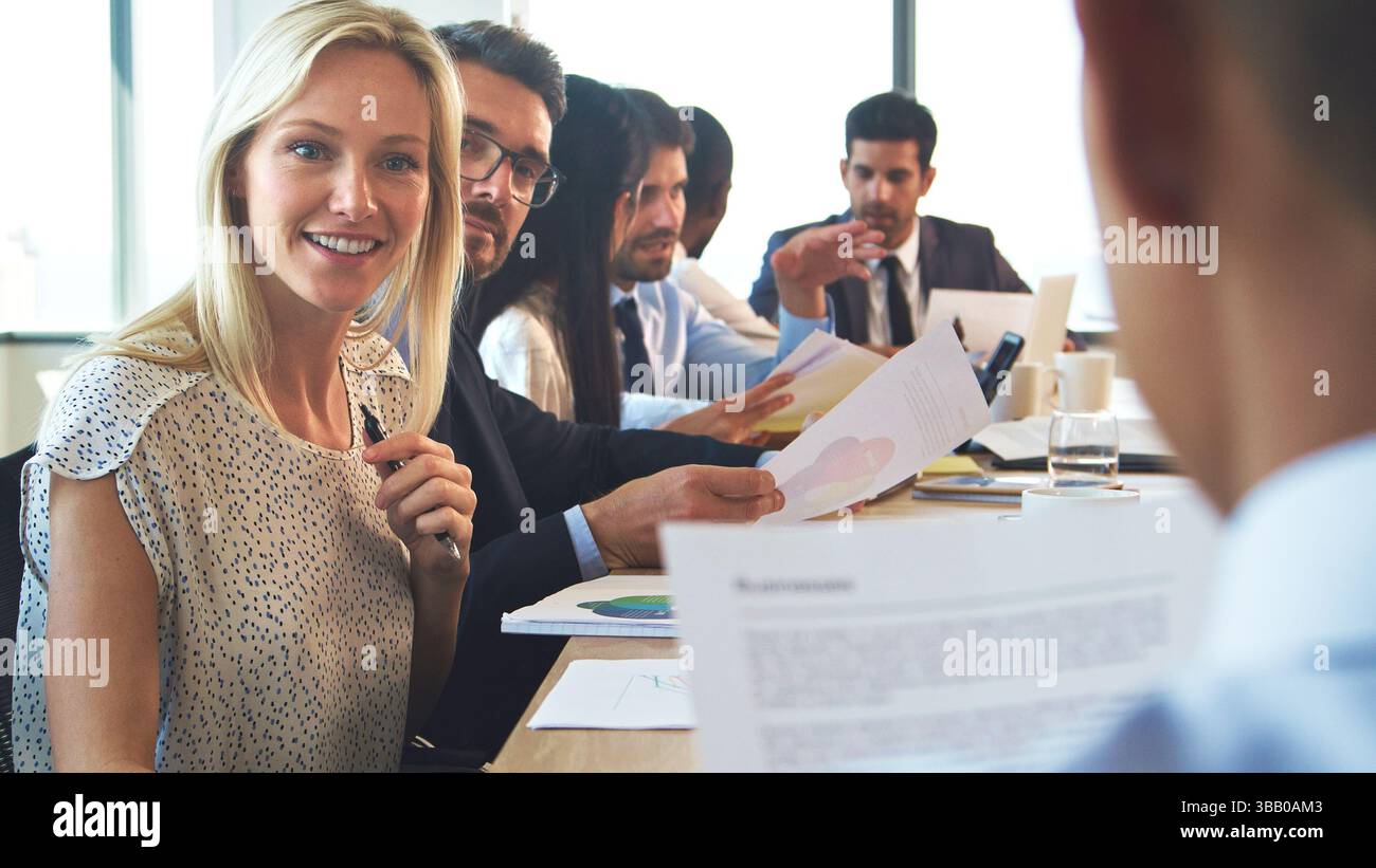 Business Team Around Table In Modern Office Collaborating Together ...