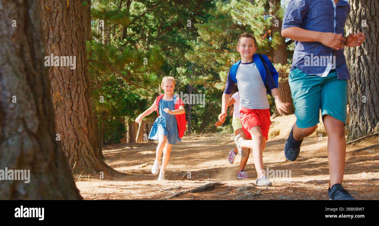 Group Of Children Running Along Trail Through Forest On Hiking ...