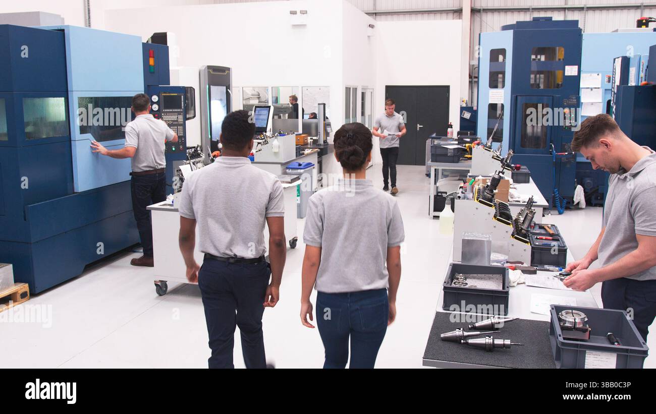 Busy Engineering Workshop With Workers Using CNC Machinery Stock Photo ...