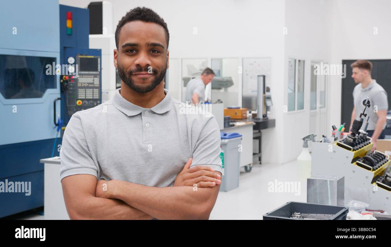 Portrait Of Male Engineer On Factory Floor Of Busy Workshop Stock Photo ...