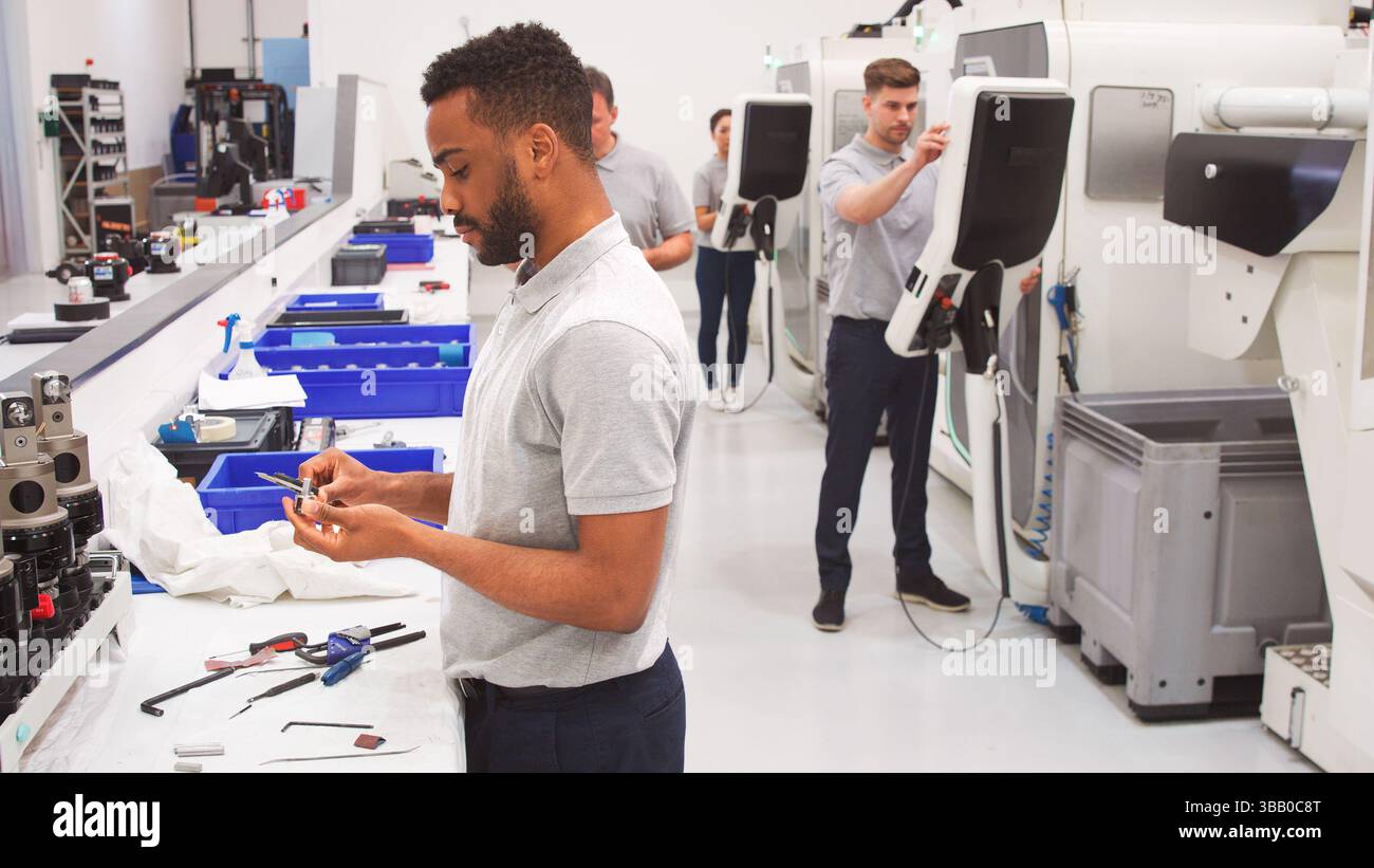 Male Engineer Measuring Components In Hi Tech Engineering Plant Stock ...