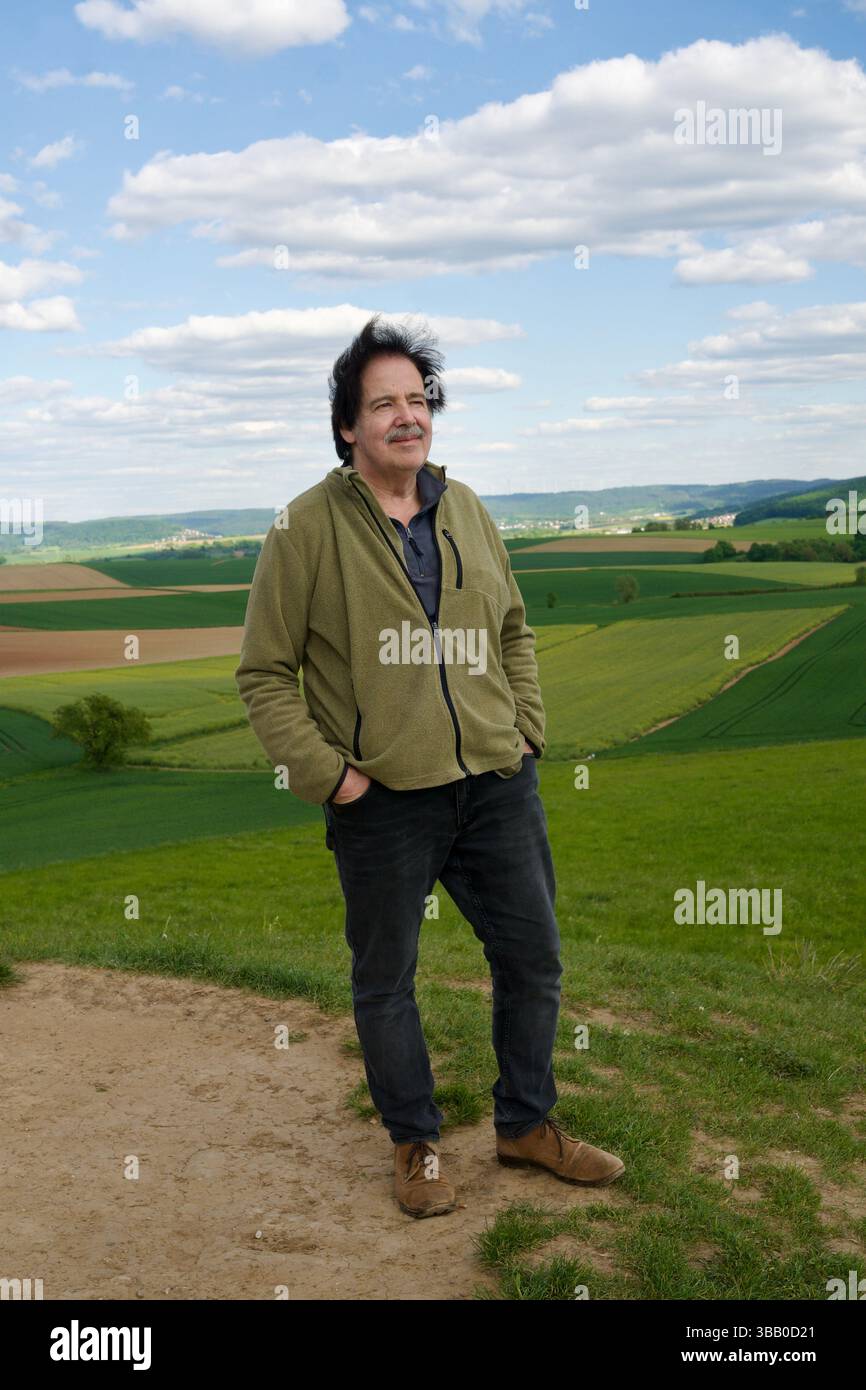 Man standing on a hill of an ancient Celtic settlement Stock Photo - Alamy