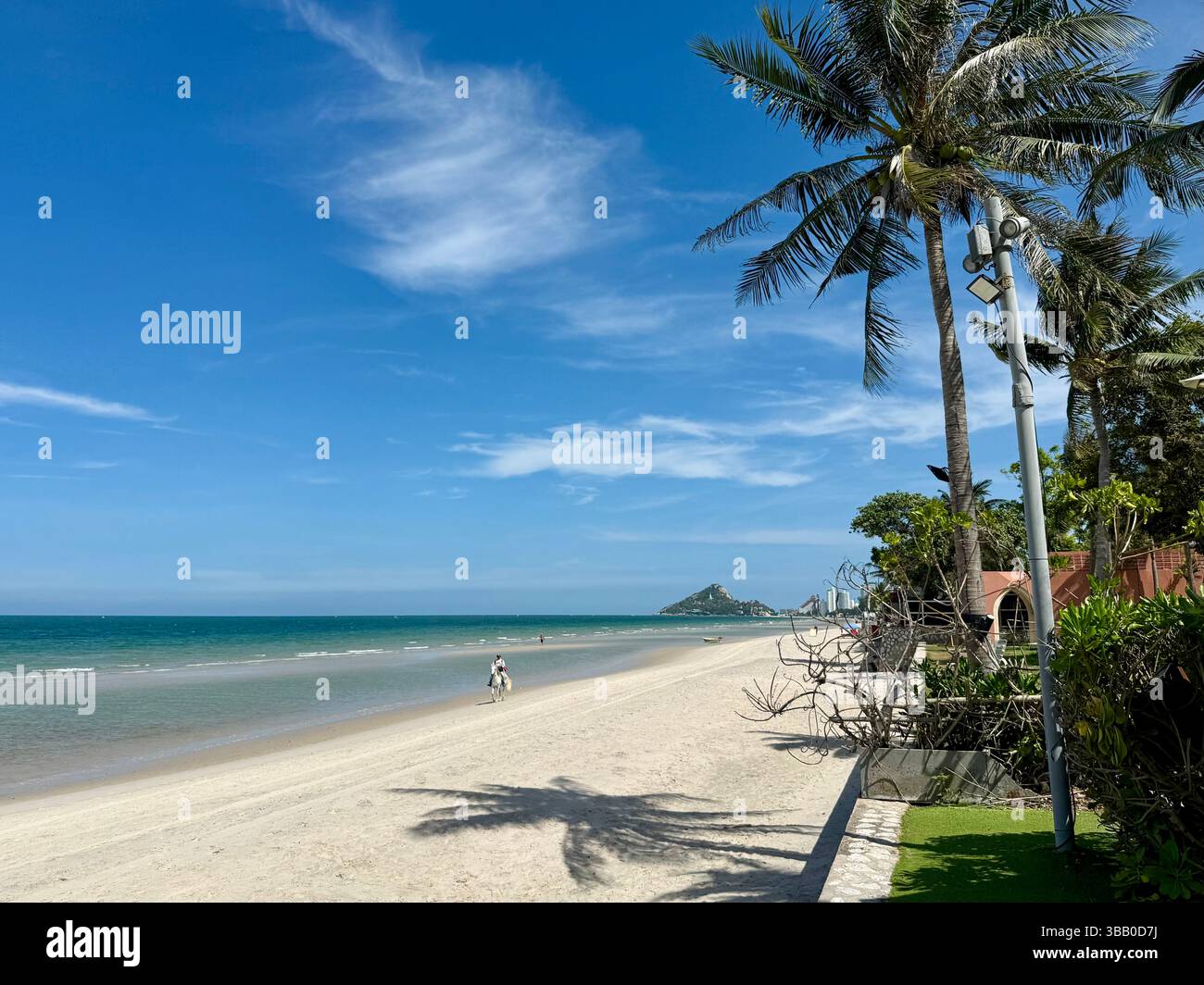 Hua Hin, Thailand. 11th May, 2025. A man rides across the white beach ...