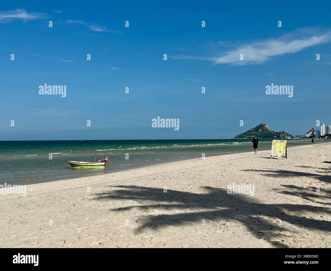 11 May 2025, Thailand, Hua Hin: A colorful boat anchors off the white ...
