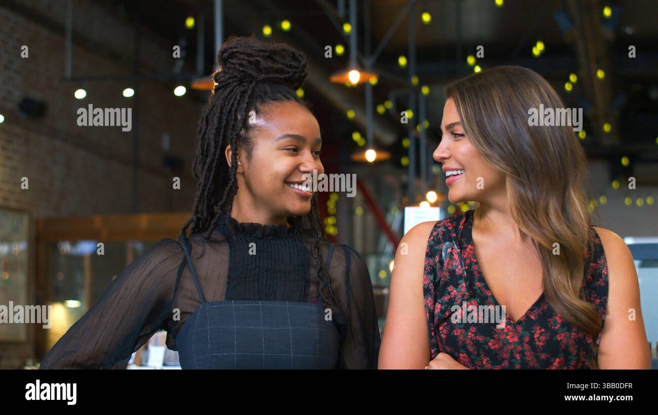 Portrait Of Two Smiling Female Members Of Staff Team In Bar Restaurant ...