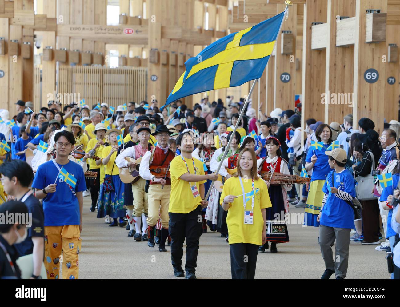 People clad in traditional Swedish costumes parade under the World ...