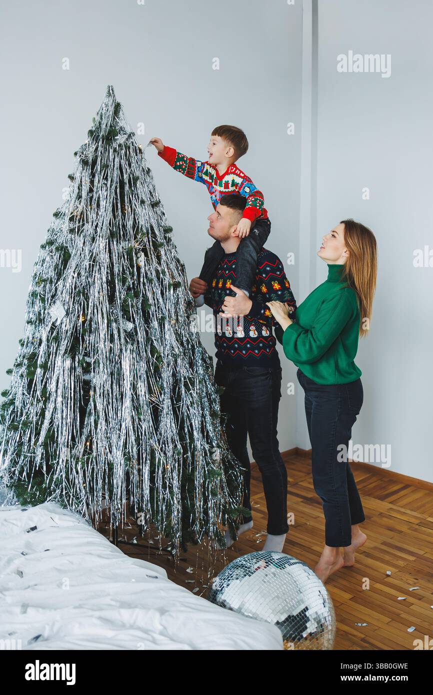 Loving family decorates christmas tree hi-res stock photography and ...